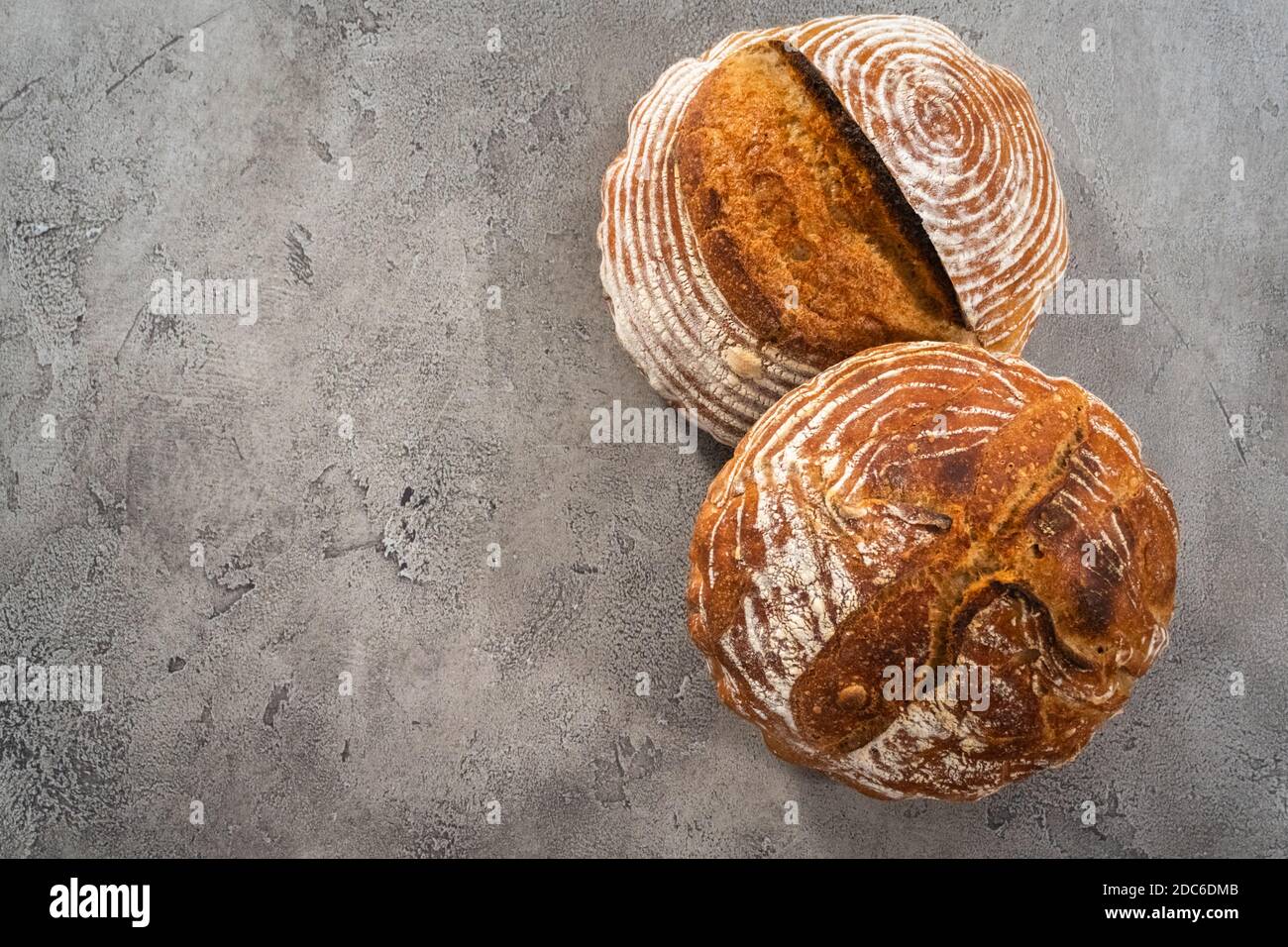 Flat lay. Freshly baked loaf of a wheat sourdough bread with marks from ...
