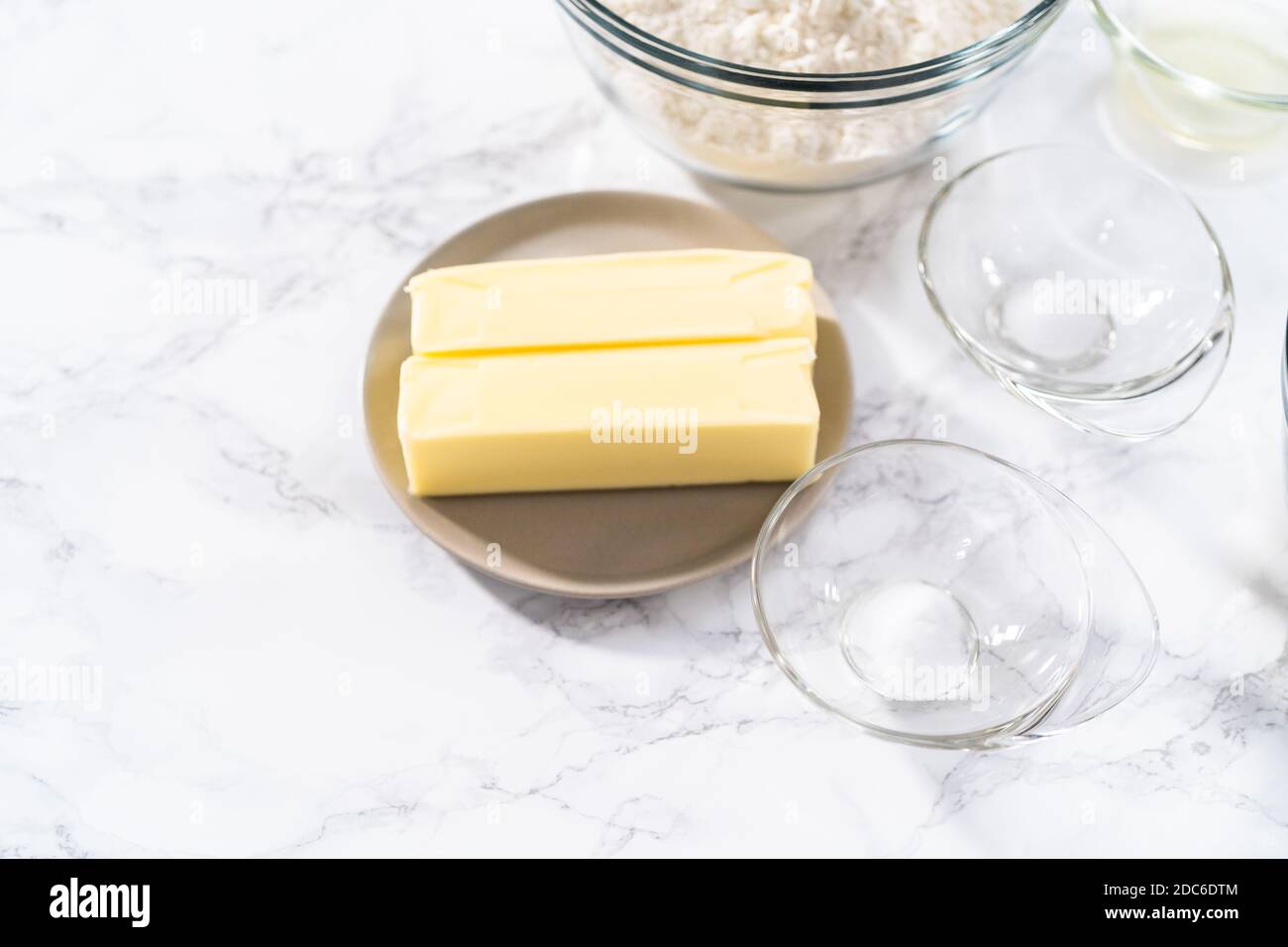 Ingredients in a glass mixing bowls to bake a lemon pound cake Stock ...
