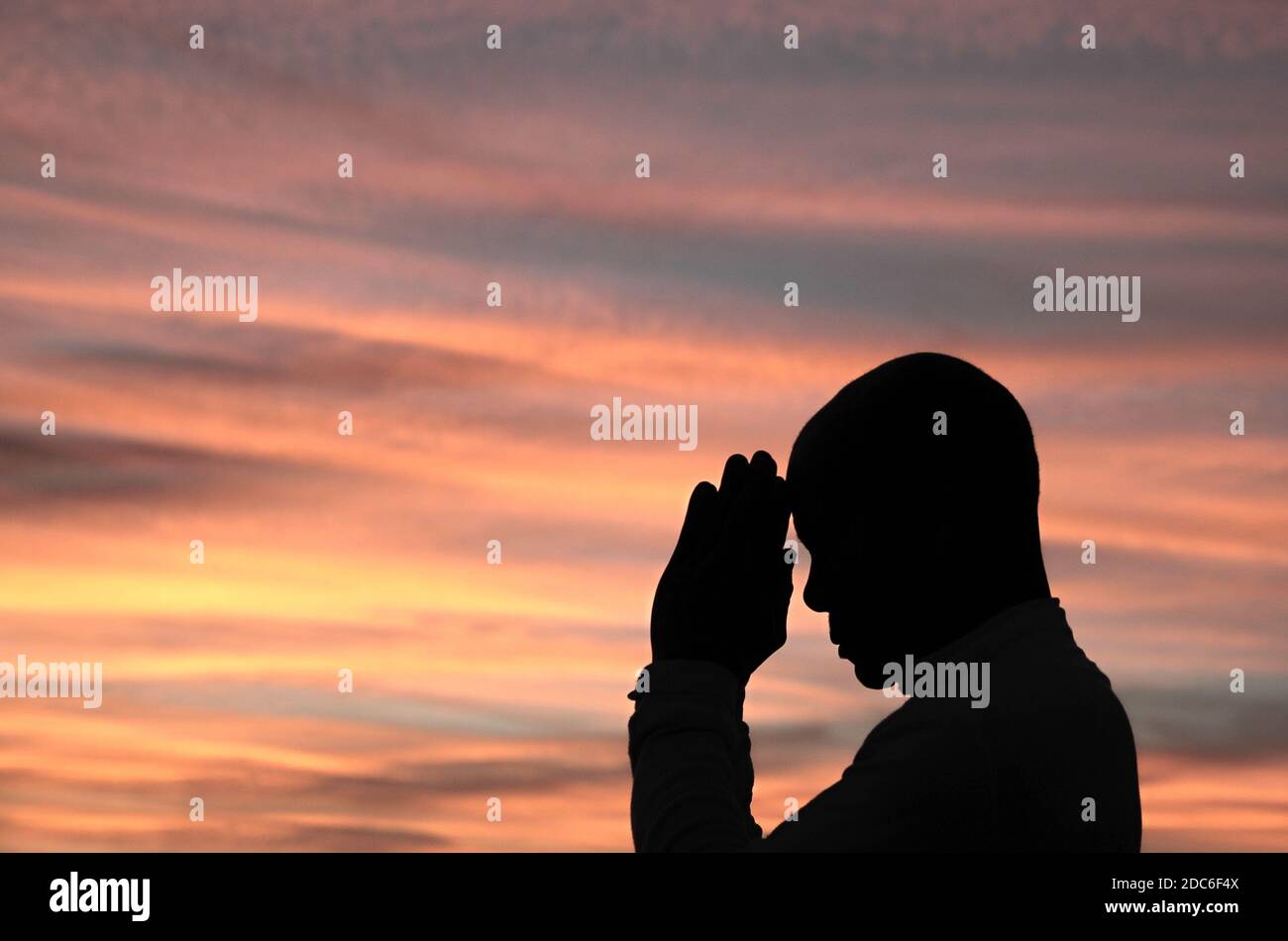 praying to god with arms outstretched to the sky sunset stock photo ...