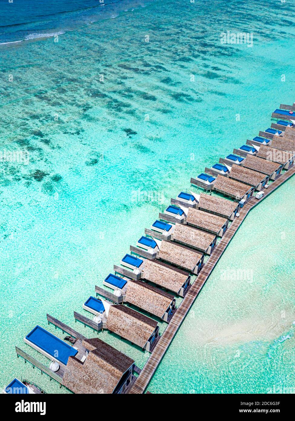 Landscape with wooden hotel on the sea, azure water, sandy beach, green ...