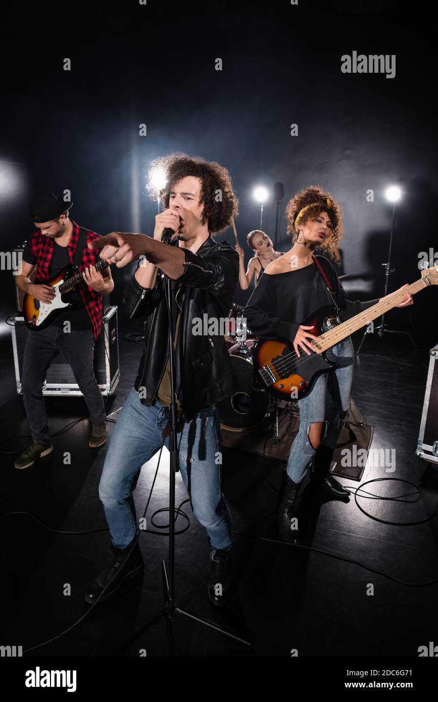 Female singer pointing to microphone hi-res stock photography and ...