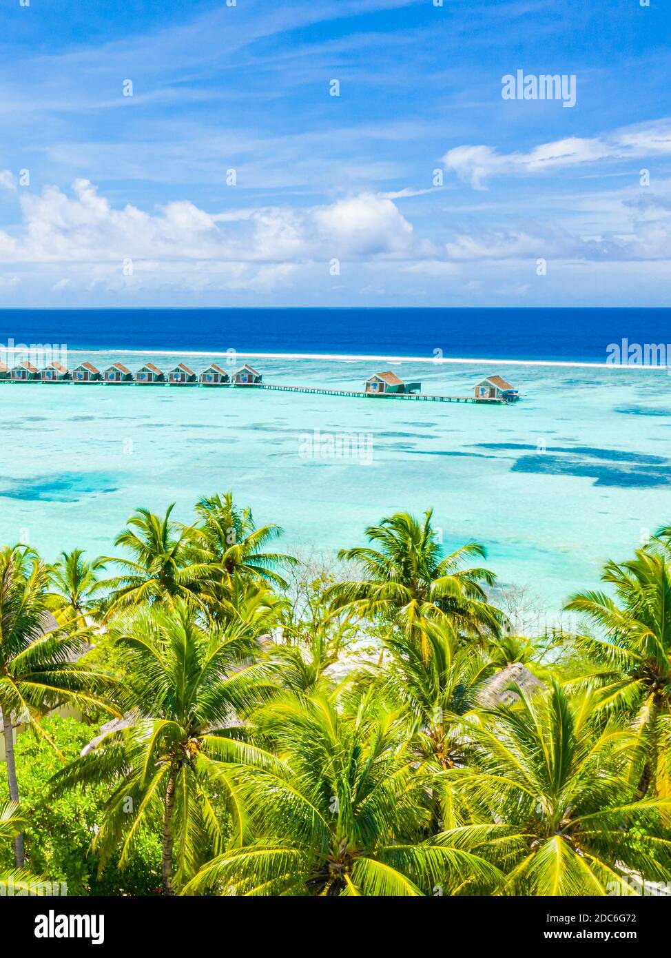 Landscape with wooden hotel on the sea, azure water, sandy beach, palm ...