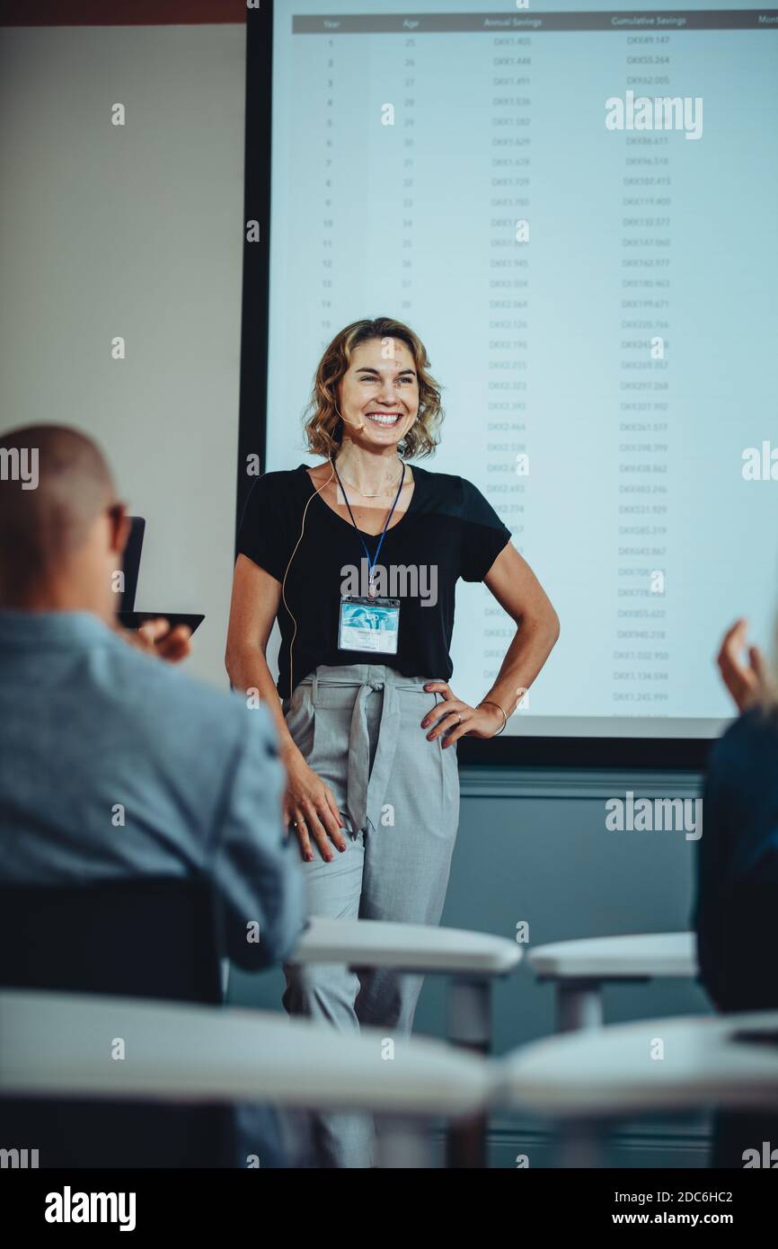 Successful businesswoman standing with people clapping hands in ...