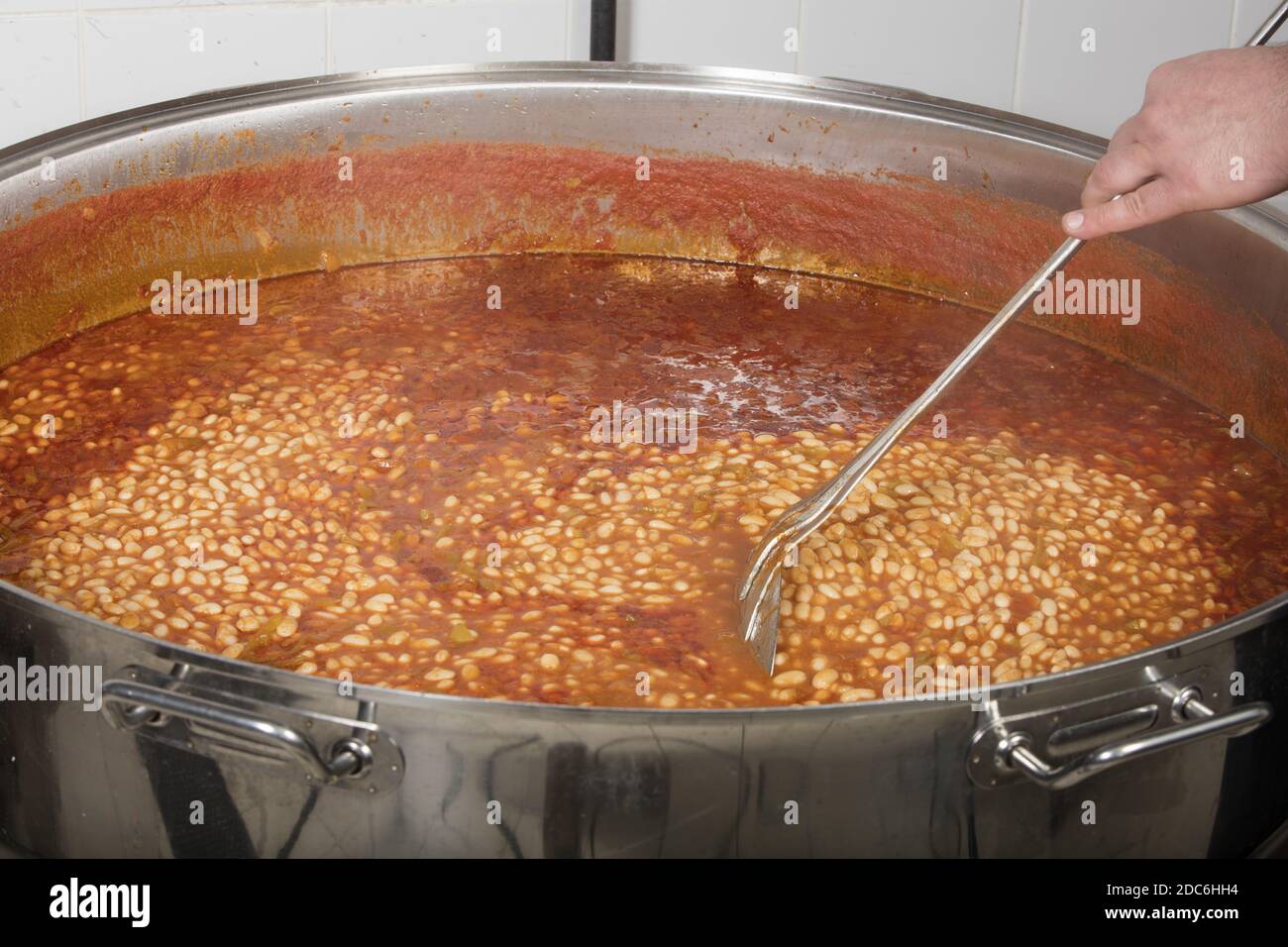 A chef cooking beans in a commercial kitchen Stock Photo - Alamy