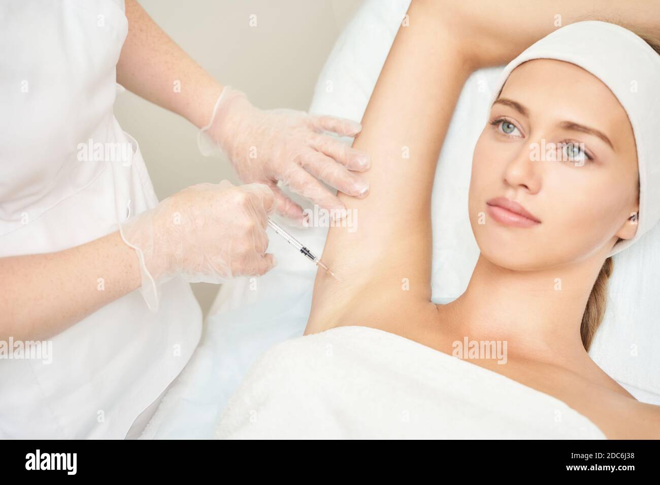 Armpit injection in spa salon. Doctor hands. Young woman Stock Photo ...