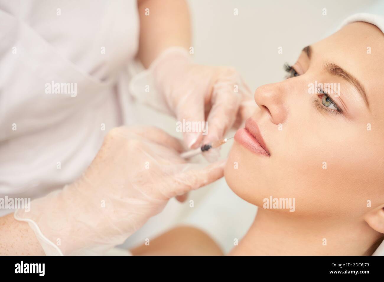 Near eye injection at spa salon. Doctor hands. Closeup. High quality ...