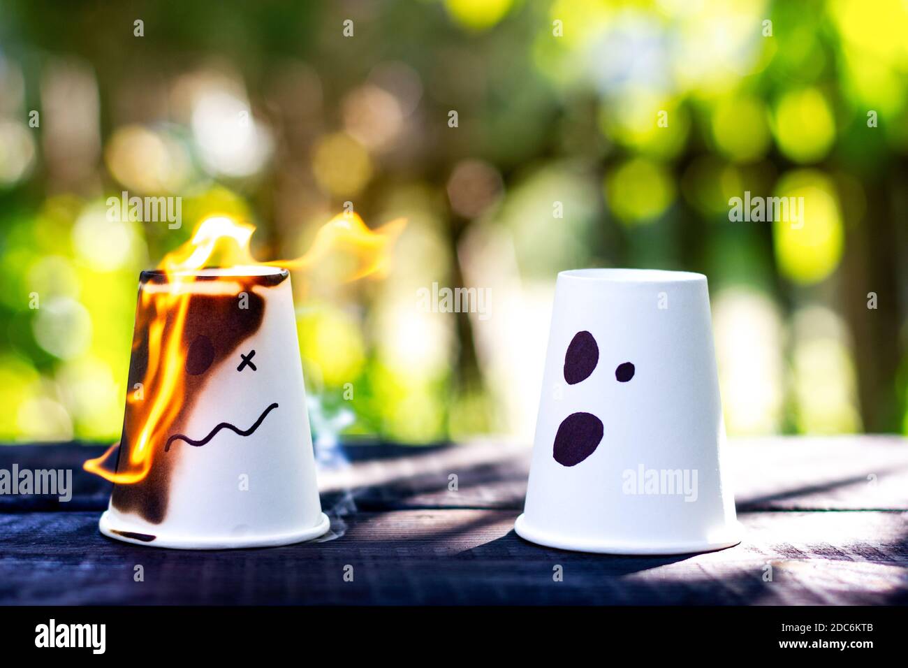 Two glasses with human emotions. Burning glass. The glass is on fire ...