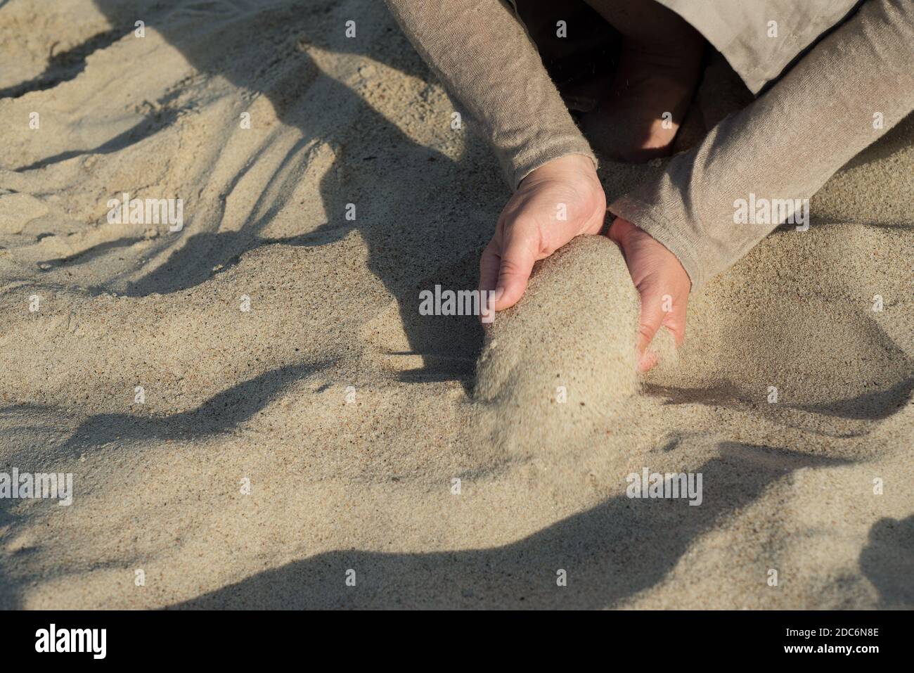 Hands on sand hi-res stock photography and images - Alamy