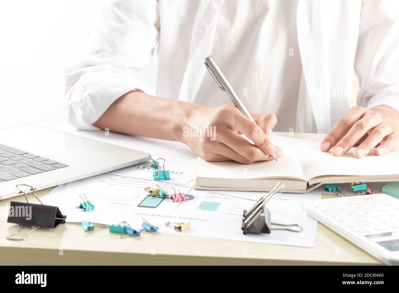 A hand of businesswoman writing on paper in the office Stock Photo - Alamy