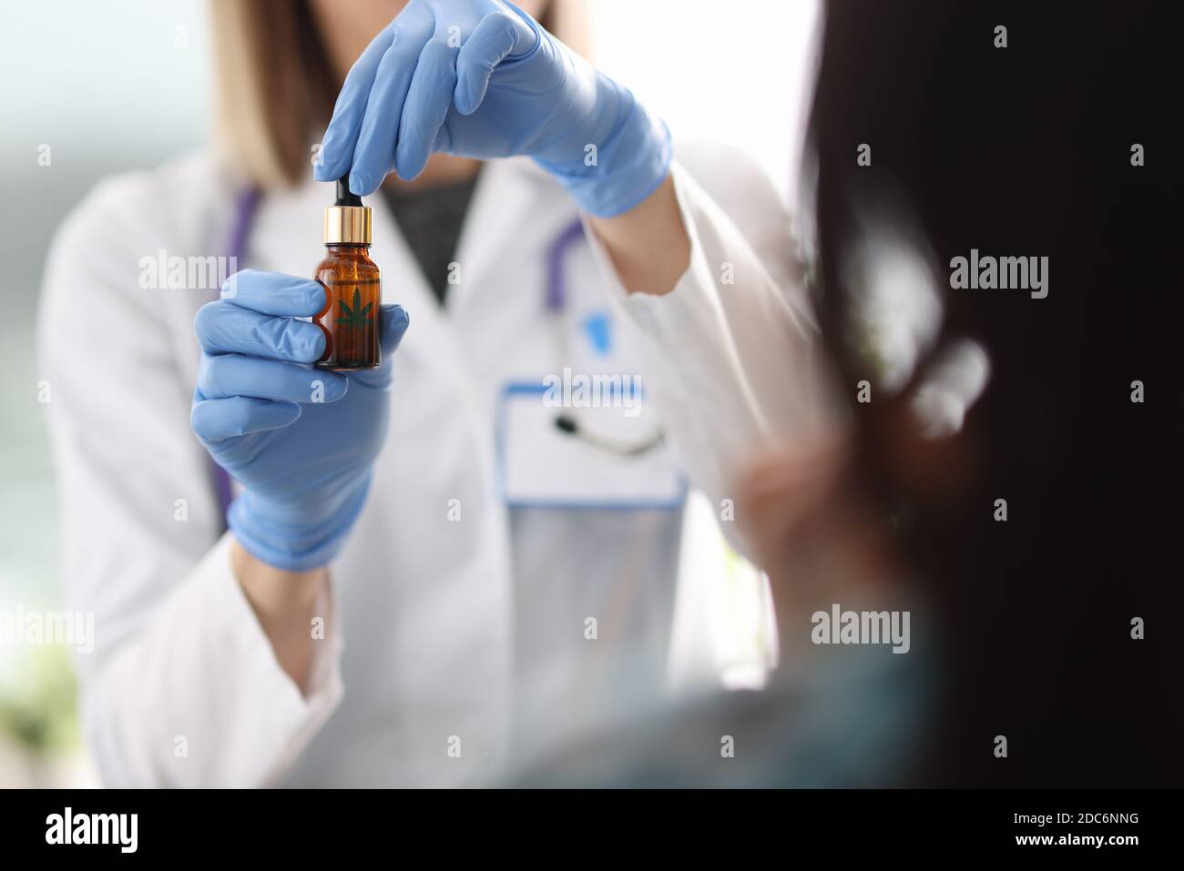 Doctor's hands hold glass bottle of marijuana Stock Photo - Alamy