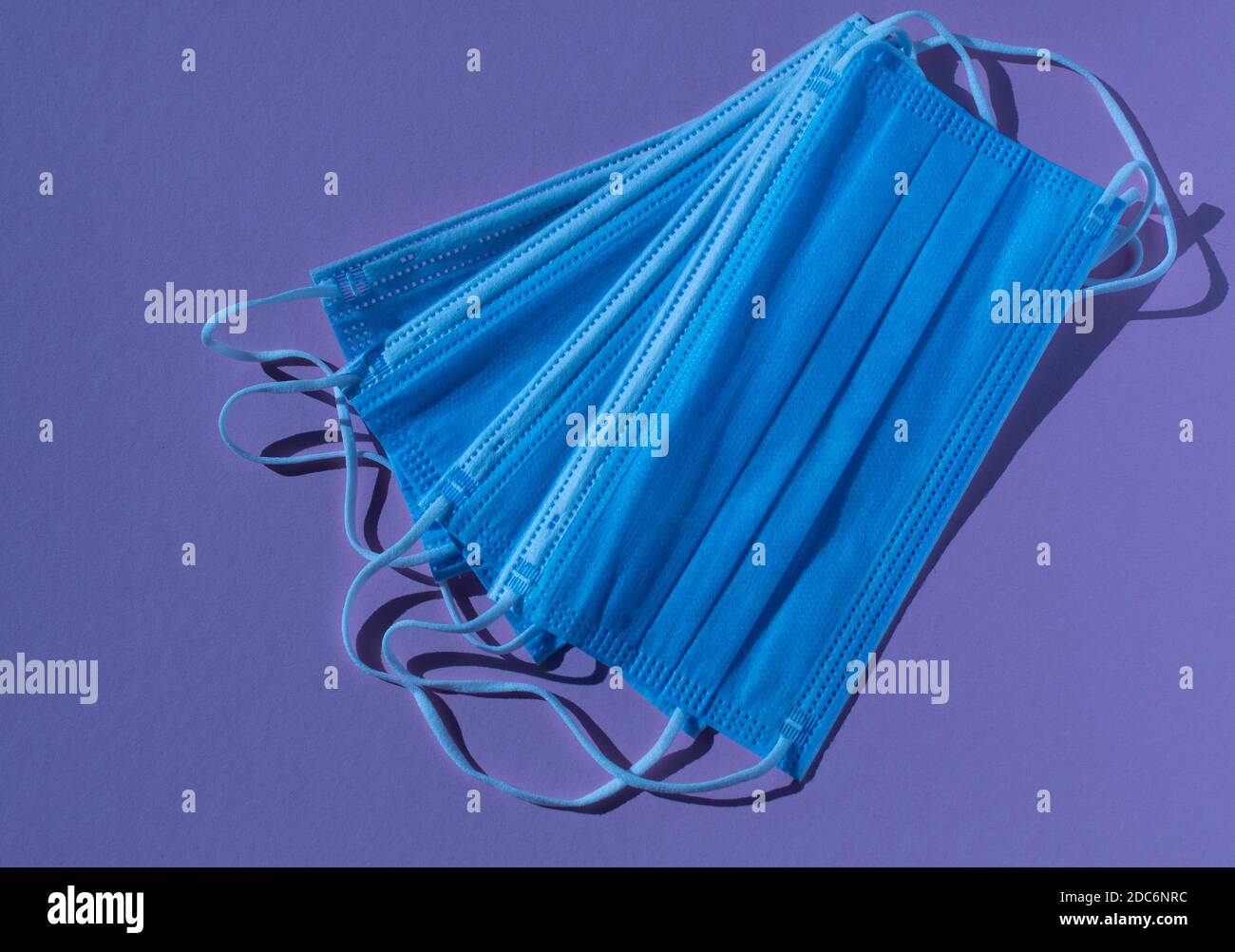 Medical mask, medical protective mask on purple background with copy ...