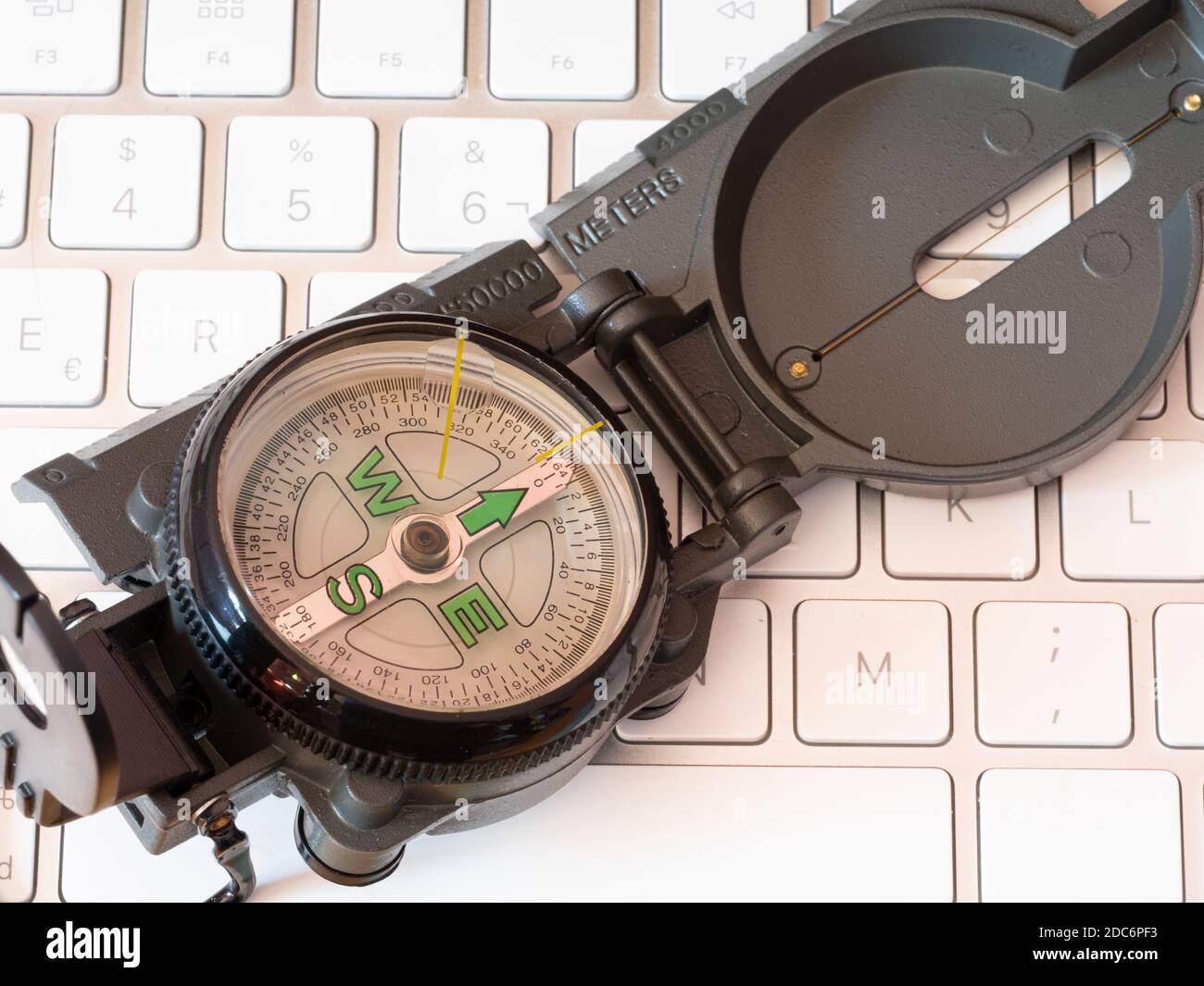 A compass on a computer keyboard Stock Photo - Alamy