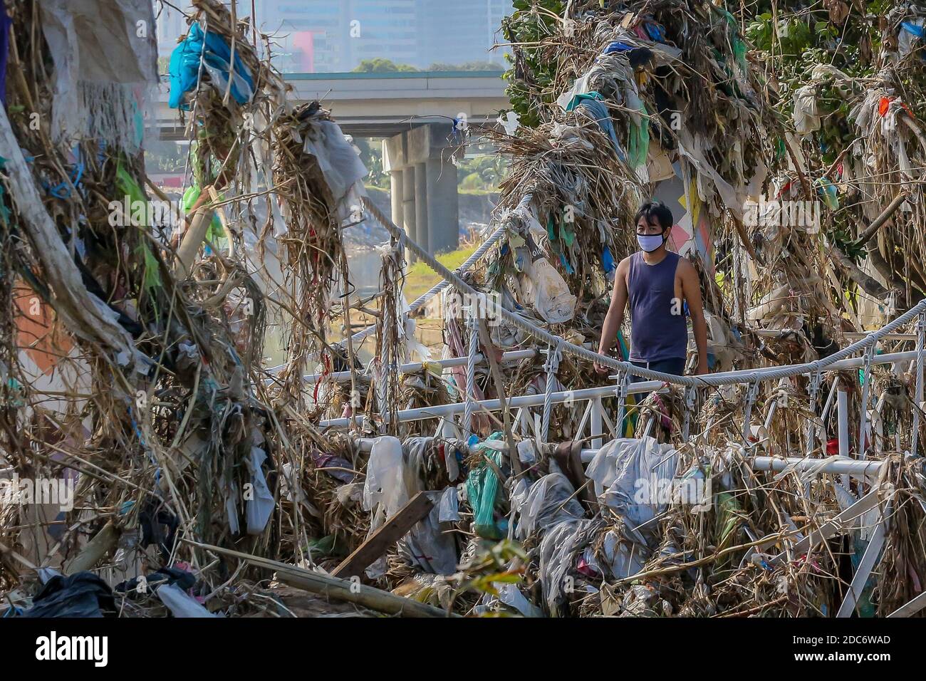 Marikina City. 19th Nov, 2020. A man walks on a bridge covered in ...