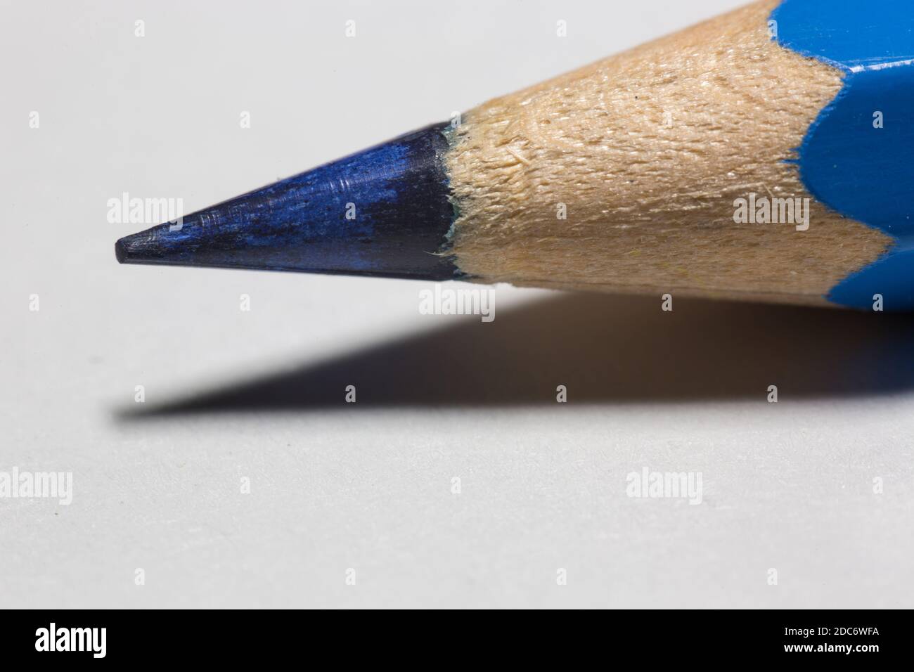 Macro of sharp blue pencil on white background Stock Photo - Alamy