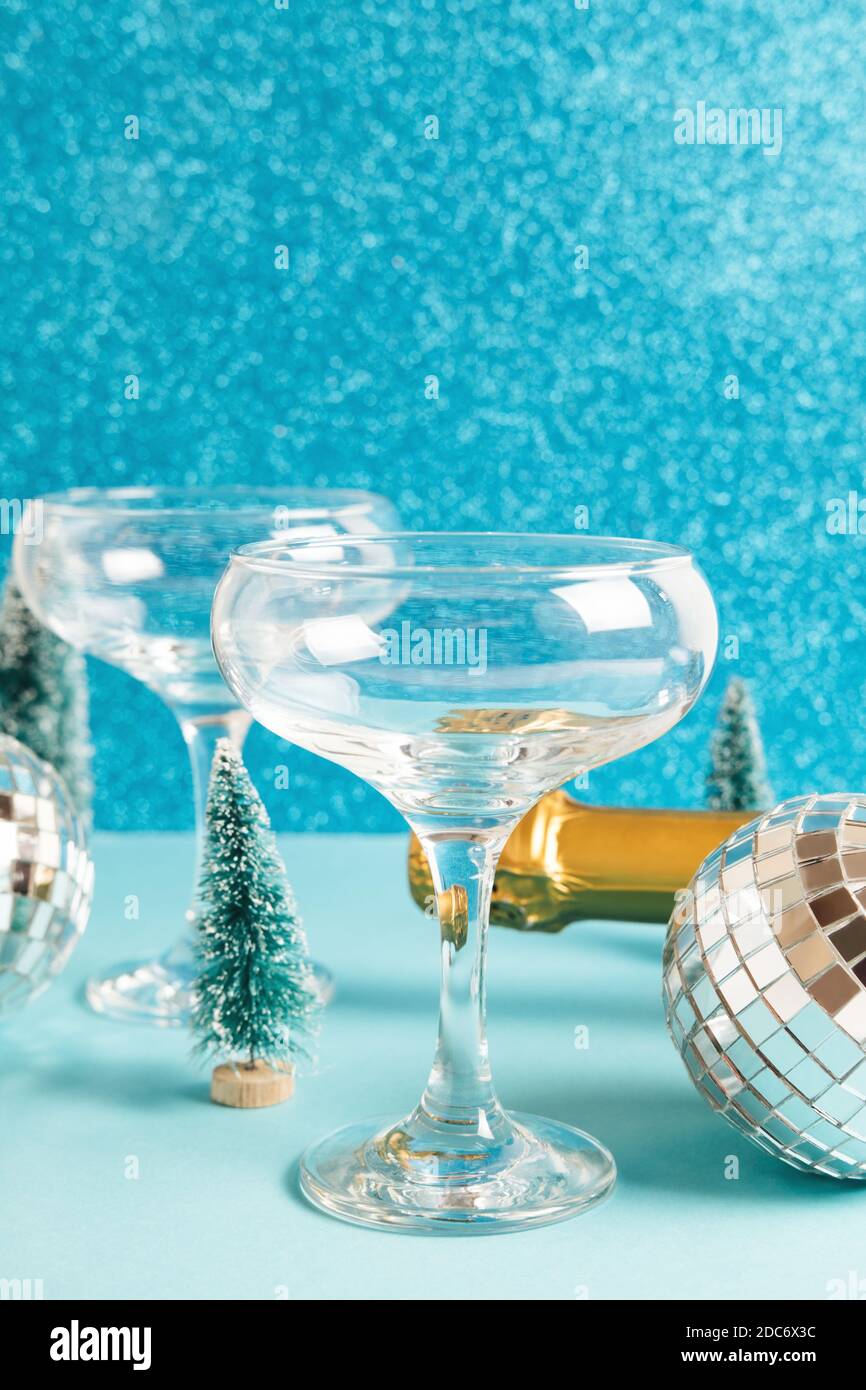 Christmas minimal festive background with disco ball, toy tree, glasses ...