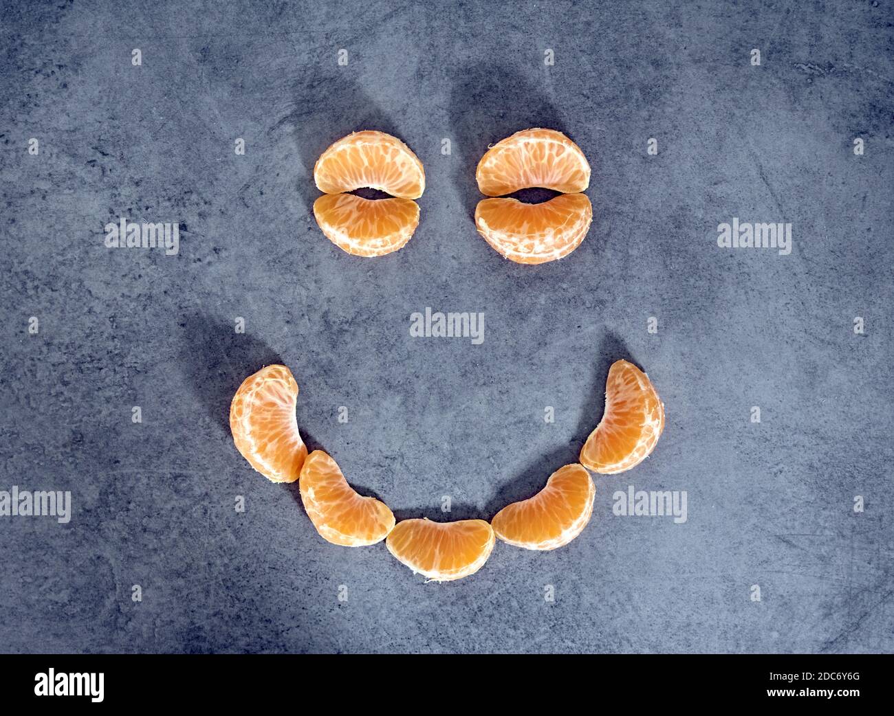 A high angle shot of tangerine pieces shaped like a smiley face Stock ...