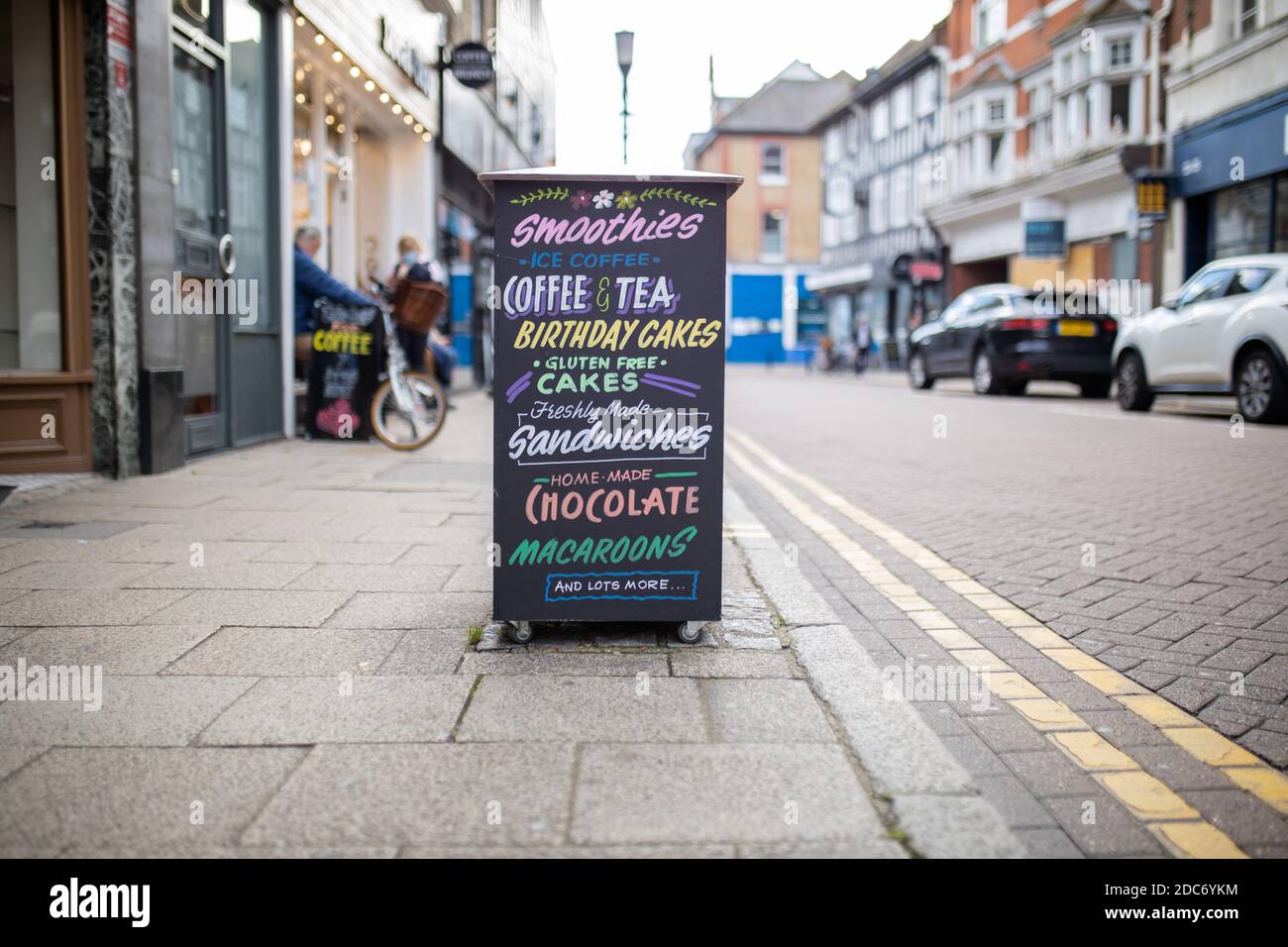 Sign with restaurant menu on the tiled sidewalk Stock Photo - Alamy