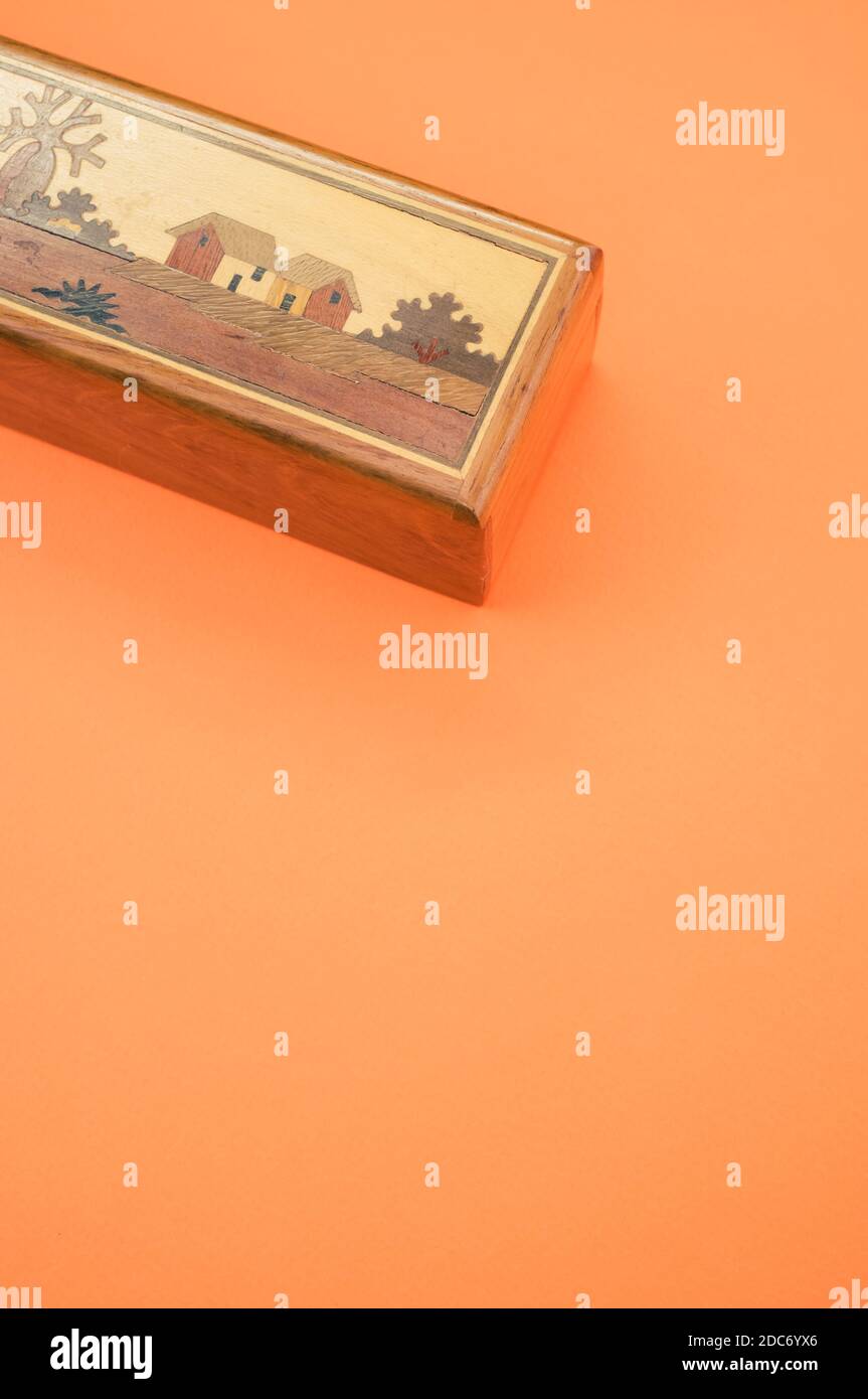 A vertical shot of a decorated wooden box on an orange surface Stock ...