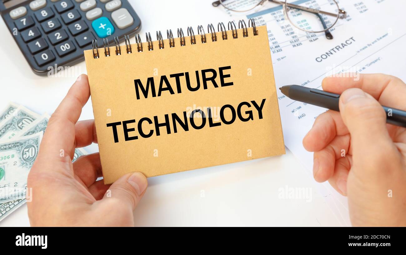 Notebook with the text Mature Technology on the office table among the stationery Stock Photo ...