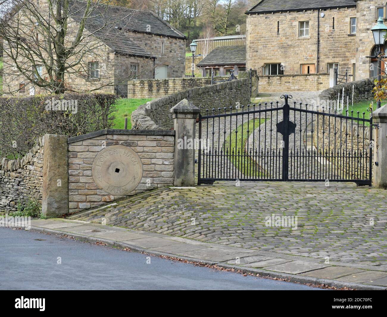 Roadside cobbled driveway stone circle set into stone wall Lower Hagg ...