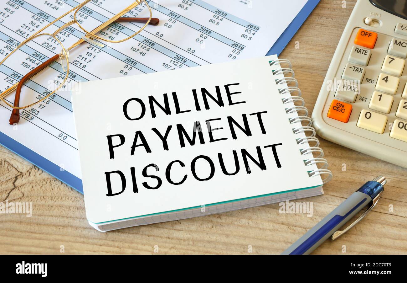 Online Payment Discount is written on a notepad on an office desk with ...