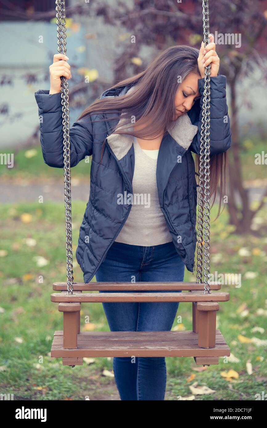 Sad woman in the playground Stock Photo - Alamy