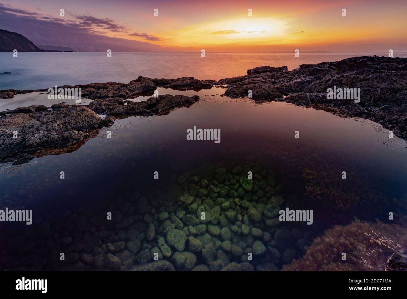 Rocks underwater in a puddle during the golden hour sunset in Tenerife ...