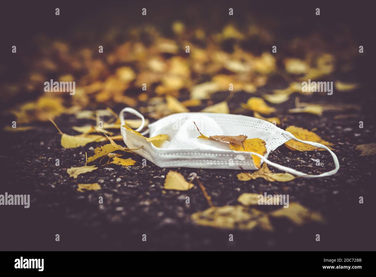 Face mask lying on the ground Stock Photo - Alamy