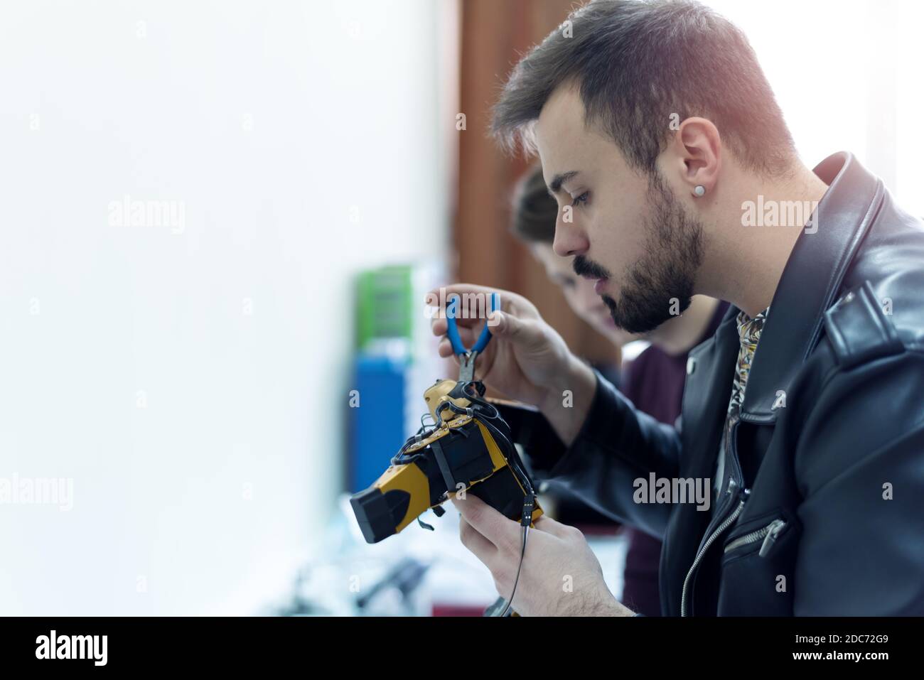 Scientists engineers designing small human robot, setting artificial ...