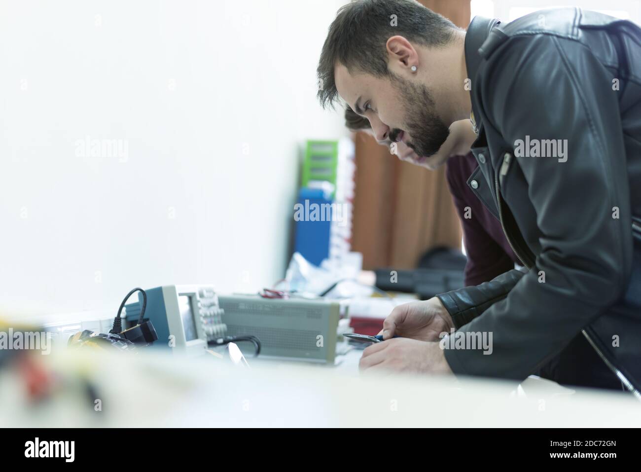 Scientists engineers designing small human robot, setting artificial ...