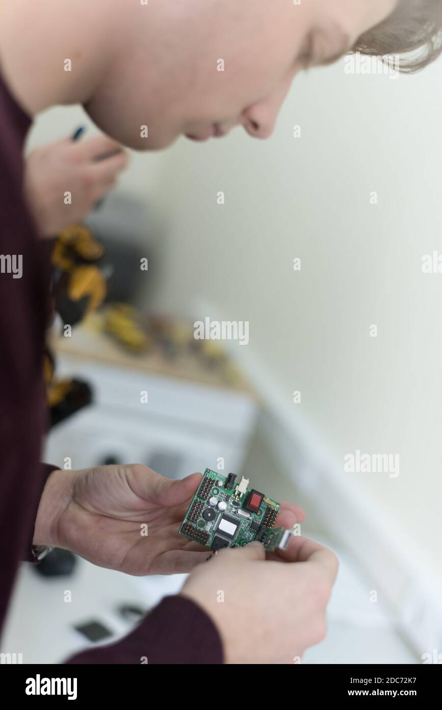 Scientists engineers designing small human robot, setting artificial ... Scientists engineers designing small human robot, setting artificial ...
