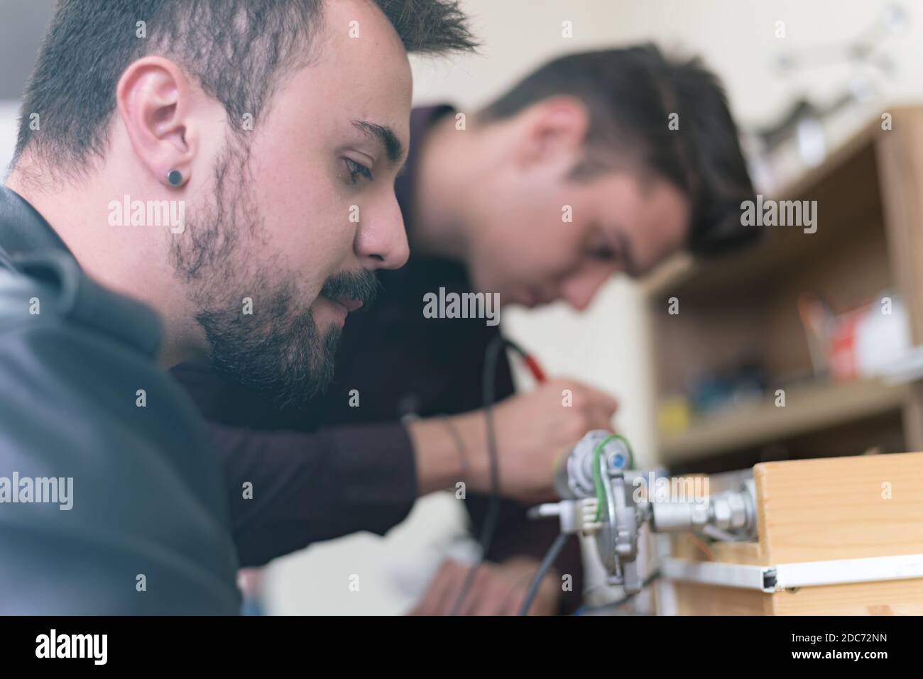 Scientists engineers designing small human robot, setting artificial ... Scientists engineers designing small human robot, setting artificial ...
