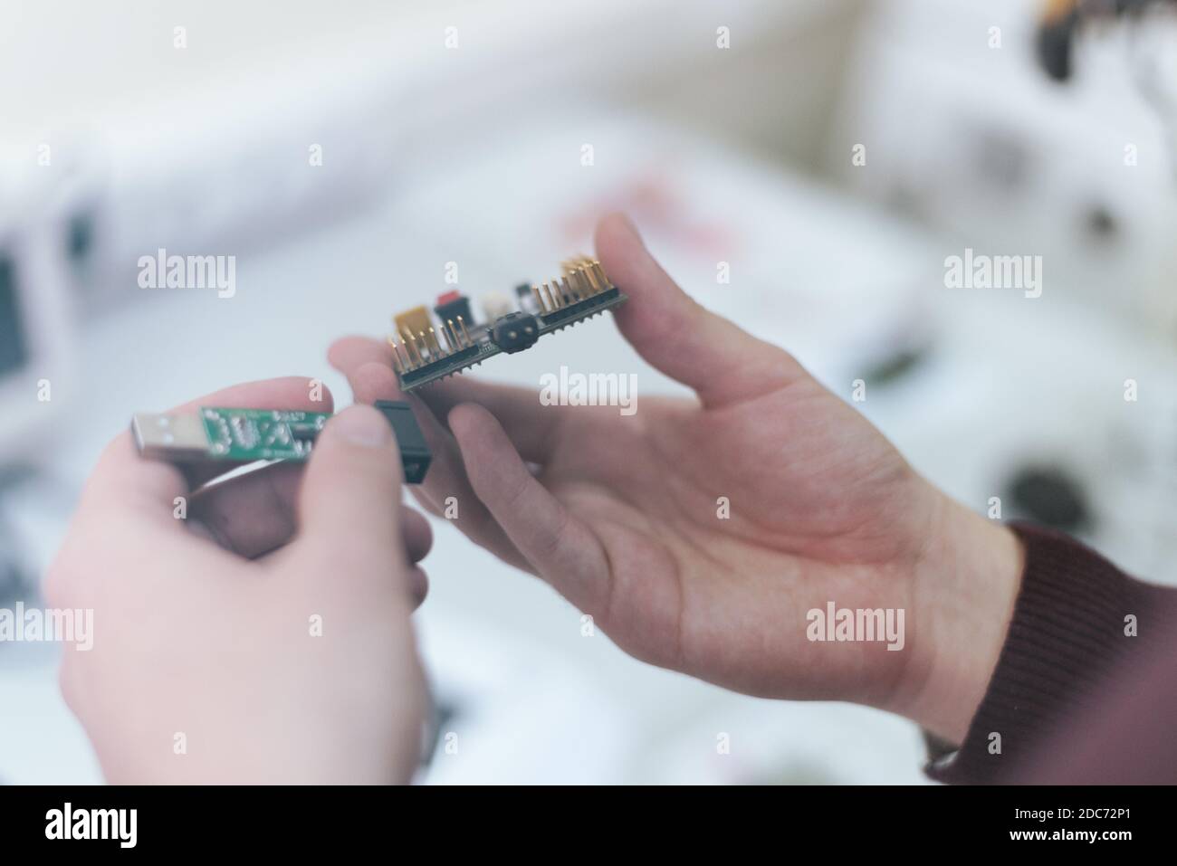 Scientists engineers designing small human robot, setting artificial ...