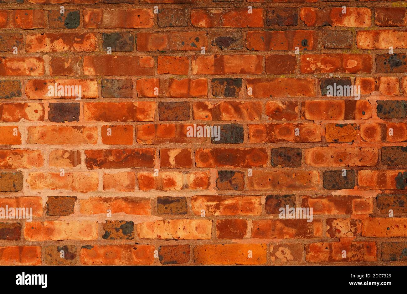 Red and orange brick wall background Stock Photo - Alamy