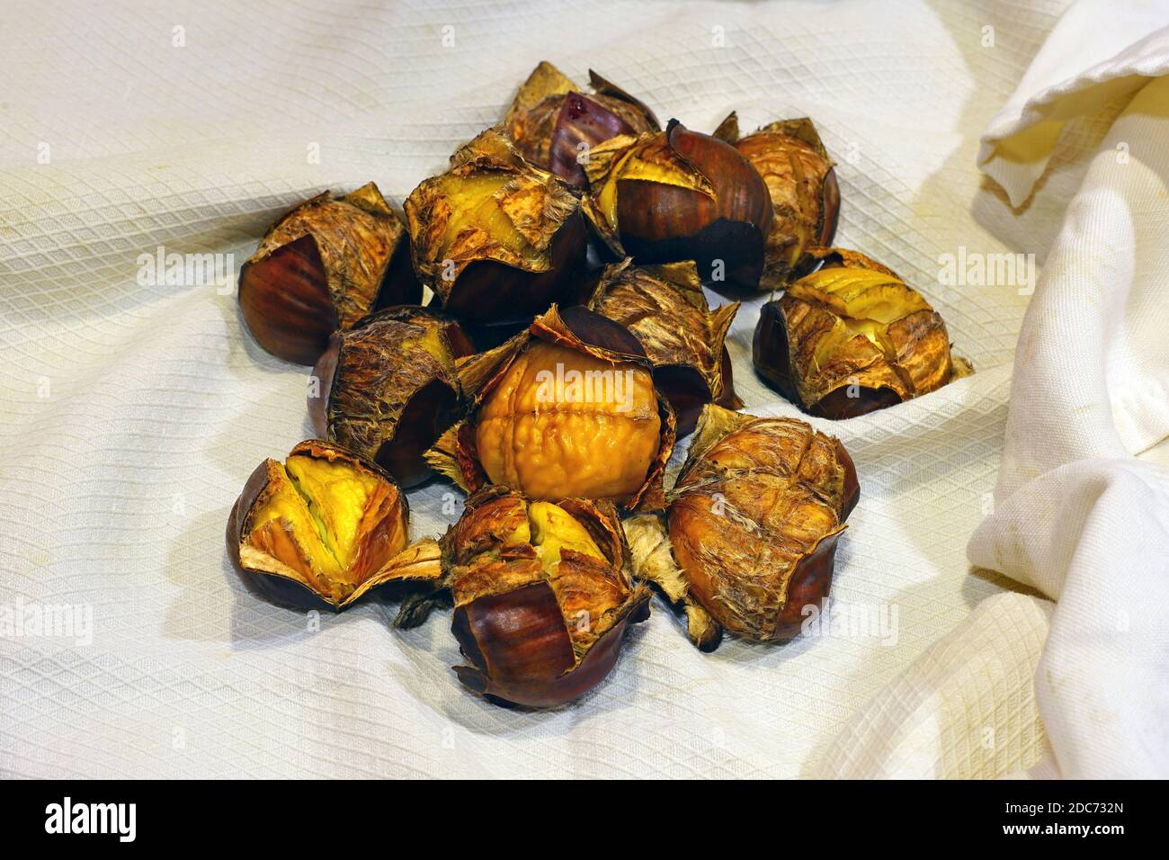 Roasted fresh chestnuts in a tea towel Stock Photo - Alamy