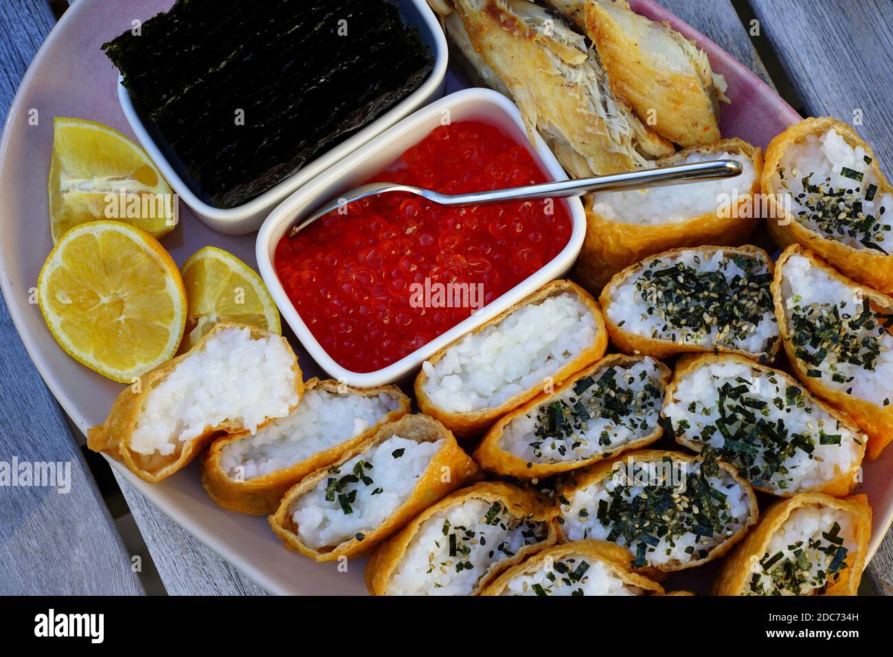 Inari rolls, tofu skins stuffed with sushi rice, with ikura salmon roe ...