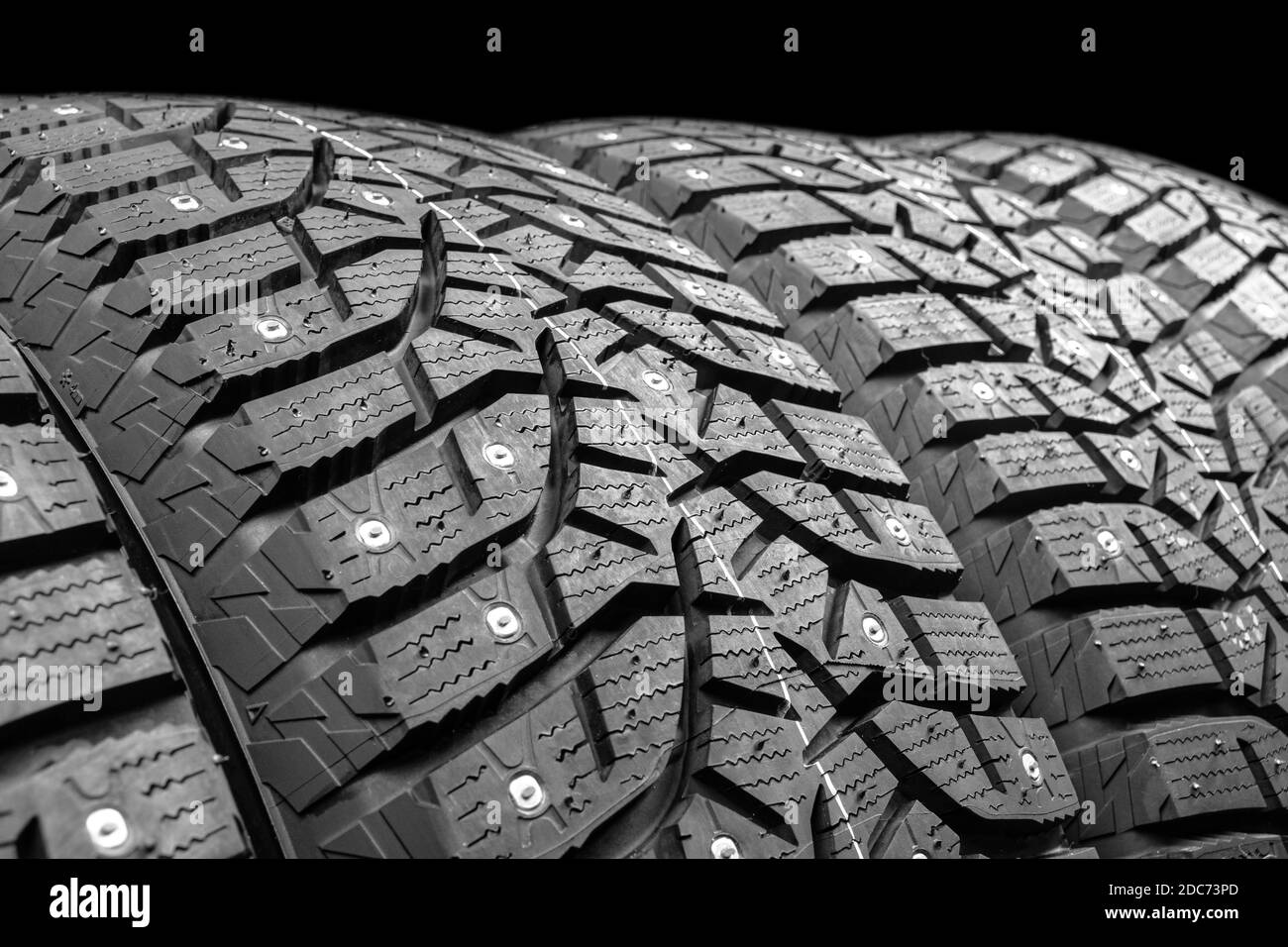 Winter studded tire. Winter car tires isolated on black background ...