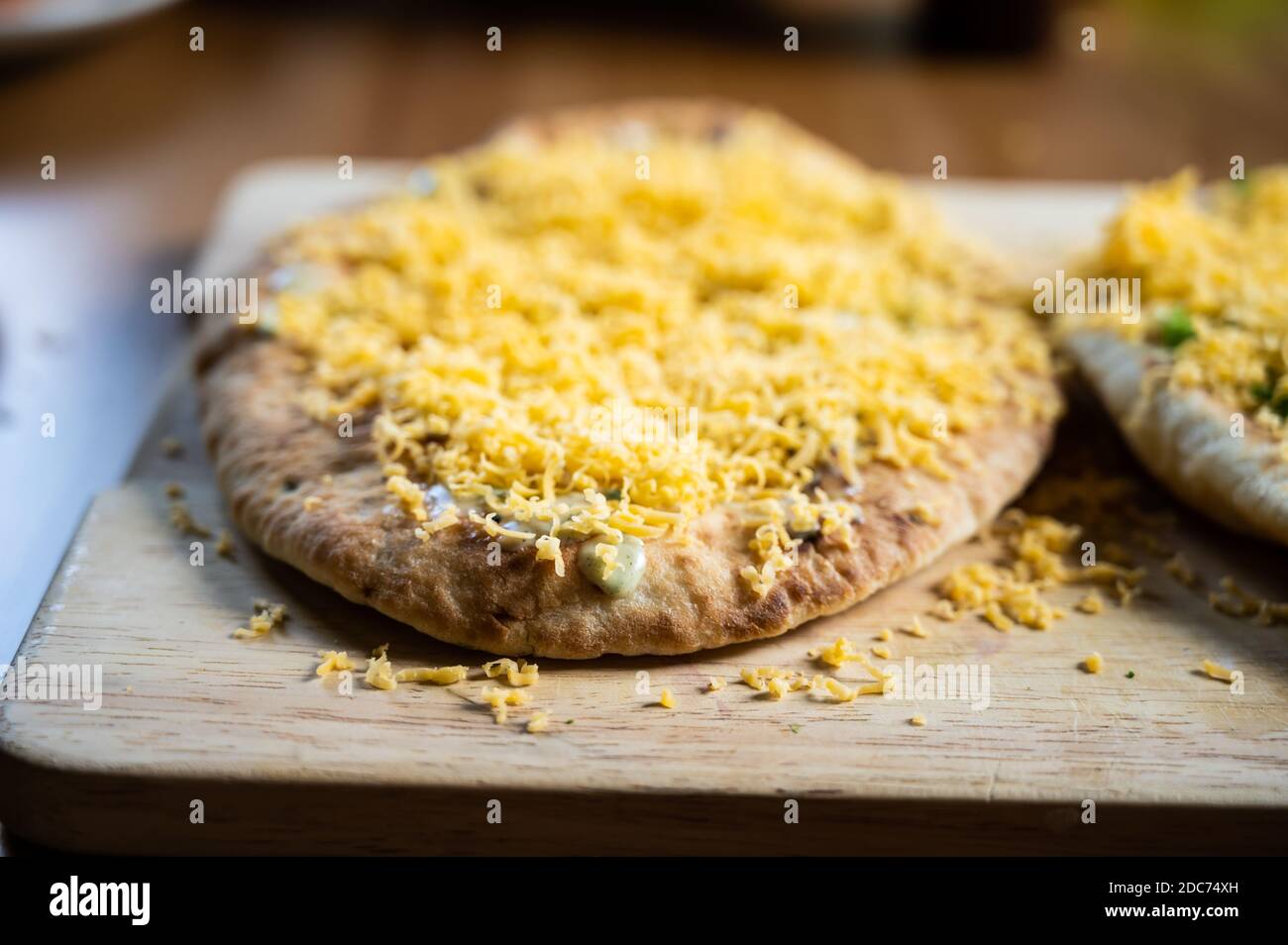 indian bread with herbs, cream and grated cheese as starter Stock Photo ...