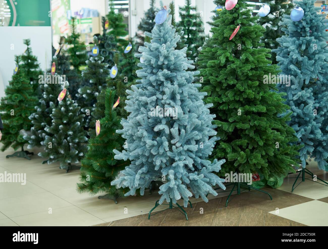 Selling PVC Christmas Trees in a Store Stock Photo - Alamy
