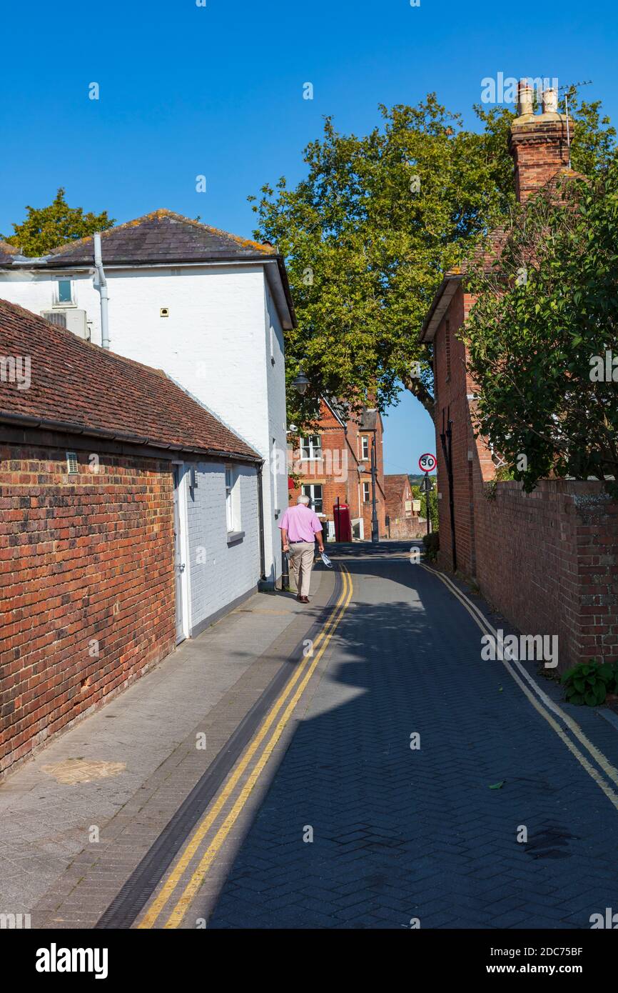 A senior citizen carrying his face mask walks past the Italian ...