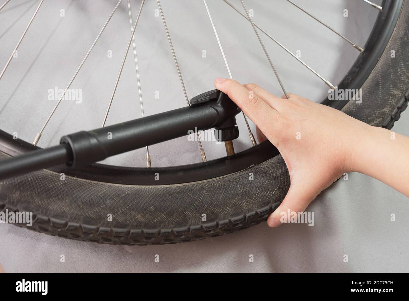teenager hands holding bicycle pump pumping up bicycle wheel Stock ...