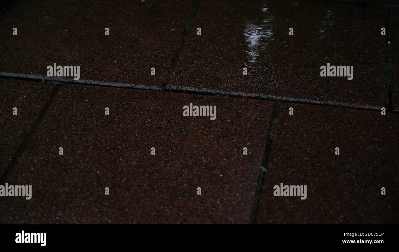 it rains heavily on tiles on a terrace in europe, first signs of ...