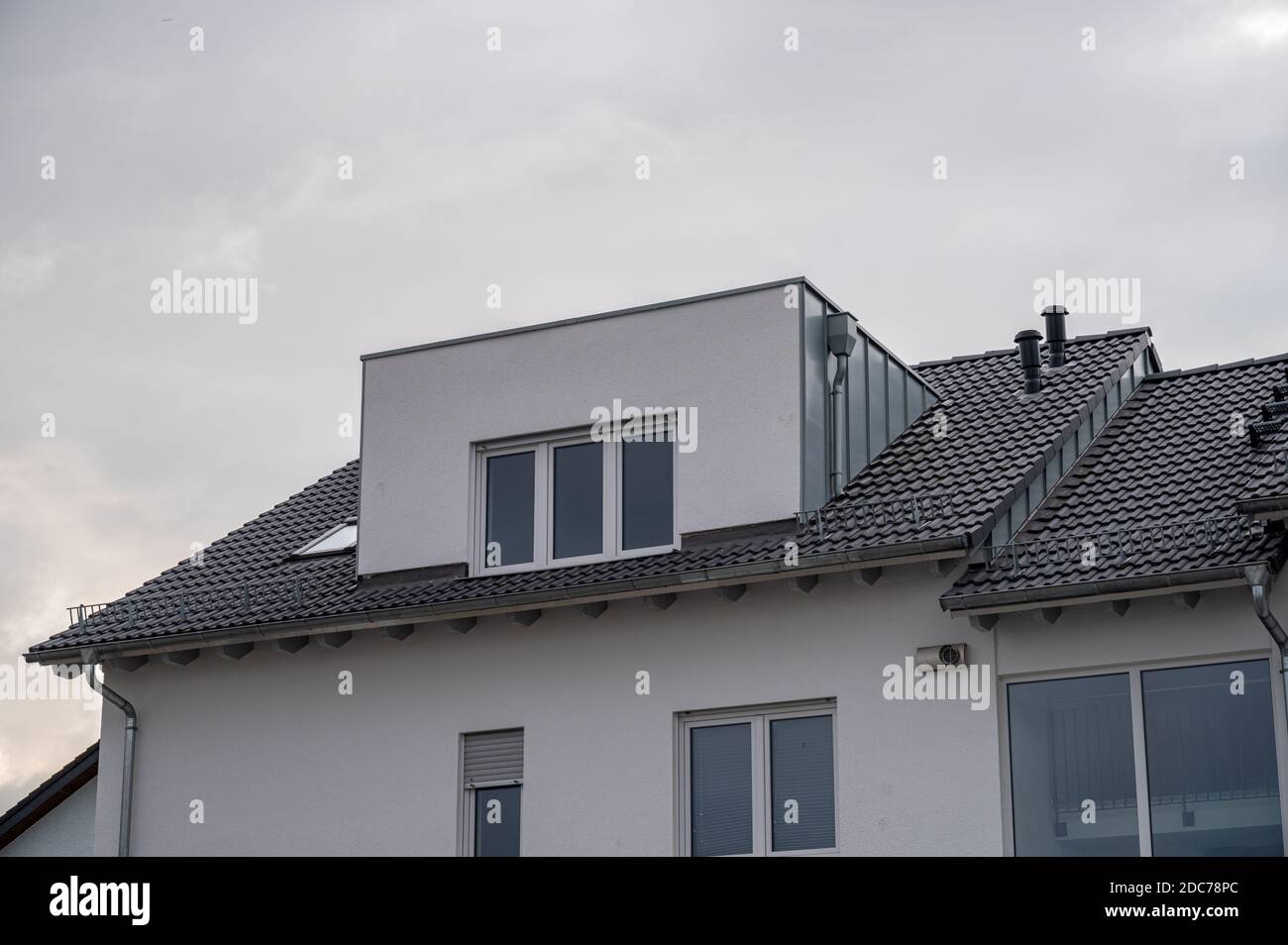 modern semi-detached house with flat roof dormer with aluminum cladding ...