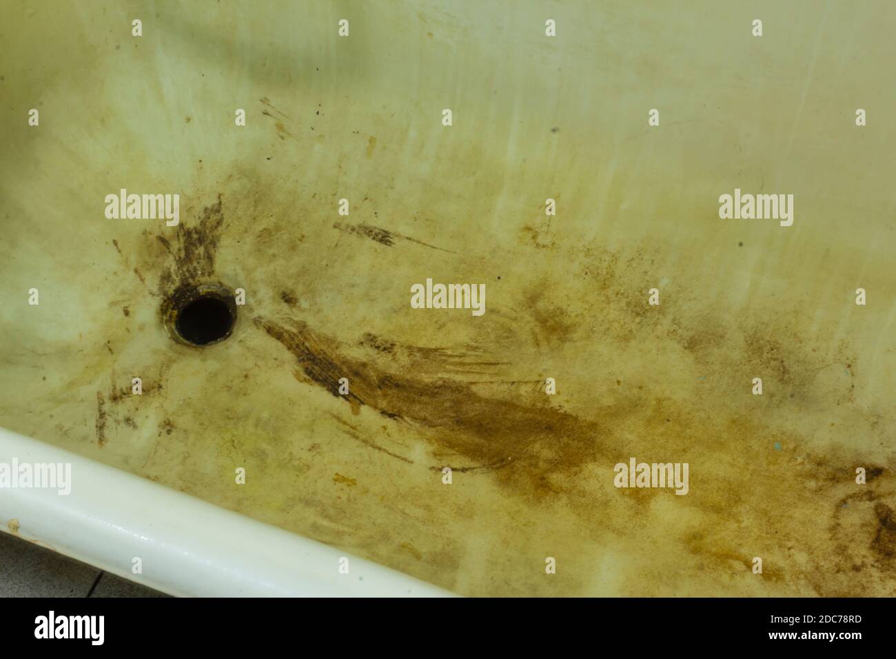 Old cast iron bathroom. Rust at the bottom. Dirt streaks on the sides ...