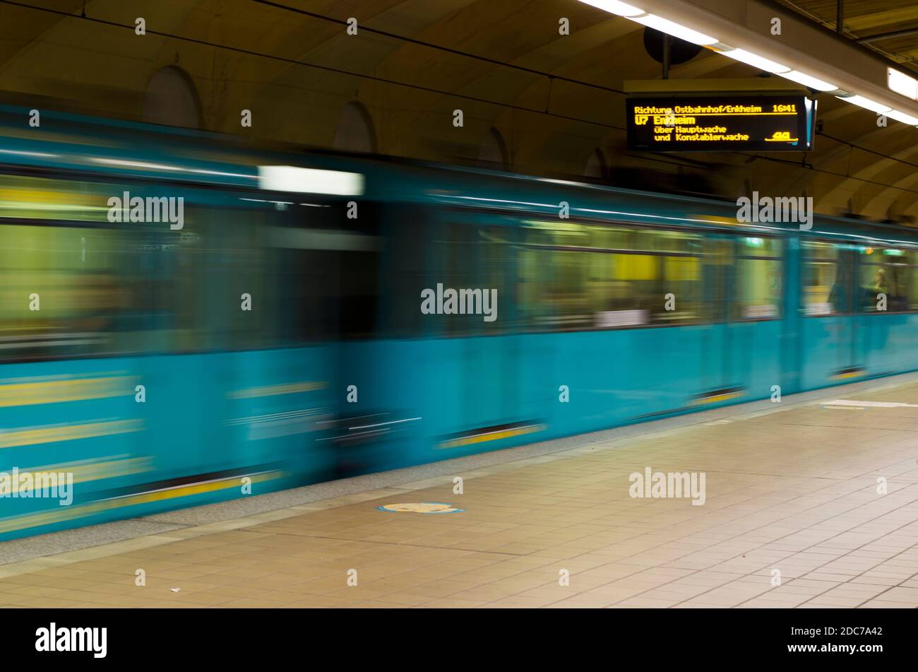 a turquoise subway train enters or leaves a subway station Stock Photo ...
