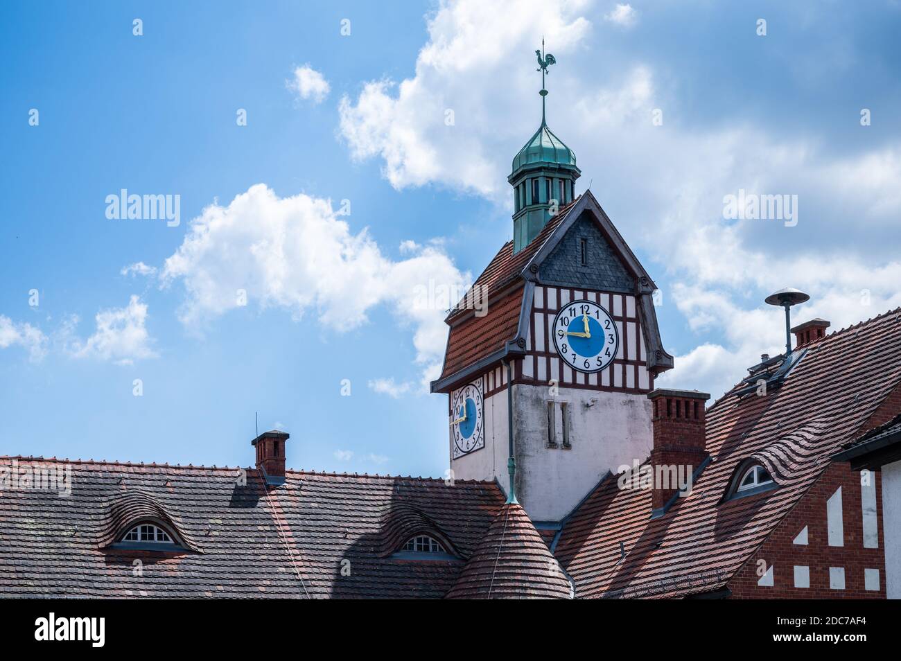 tower clock with copper wind cock and red roof tiles Stock Photo - Alamy