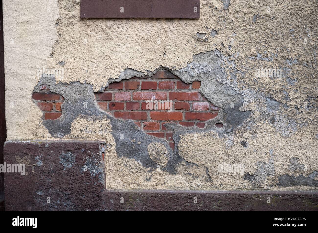 brick wall where the plaster crumbles down, as a sign of decay Stock ...