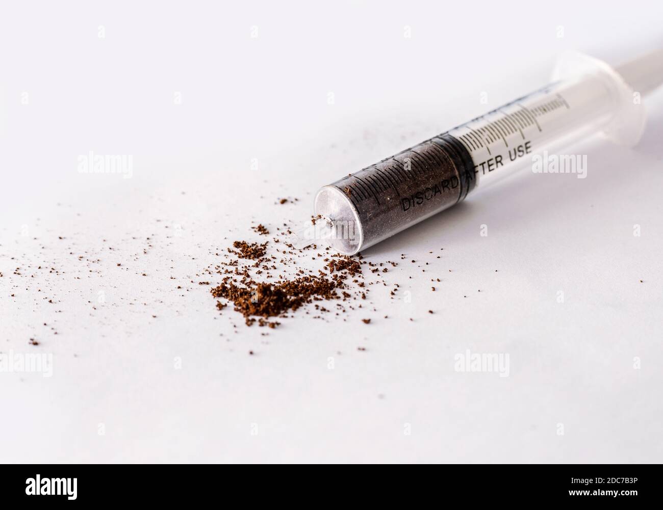 Creative concept of a coffee shot, ground coffee in a plastic syringe ...