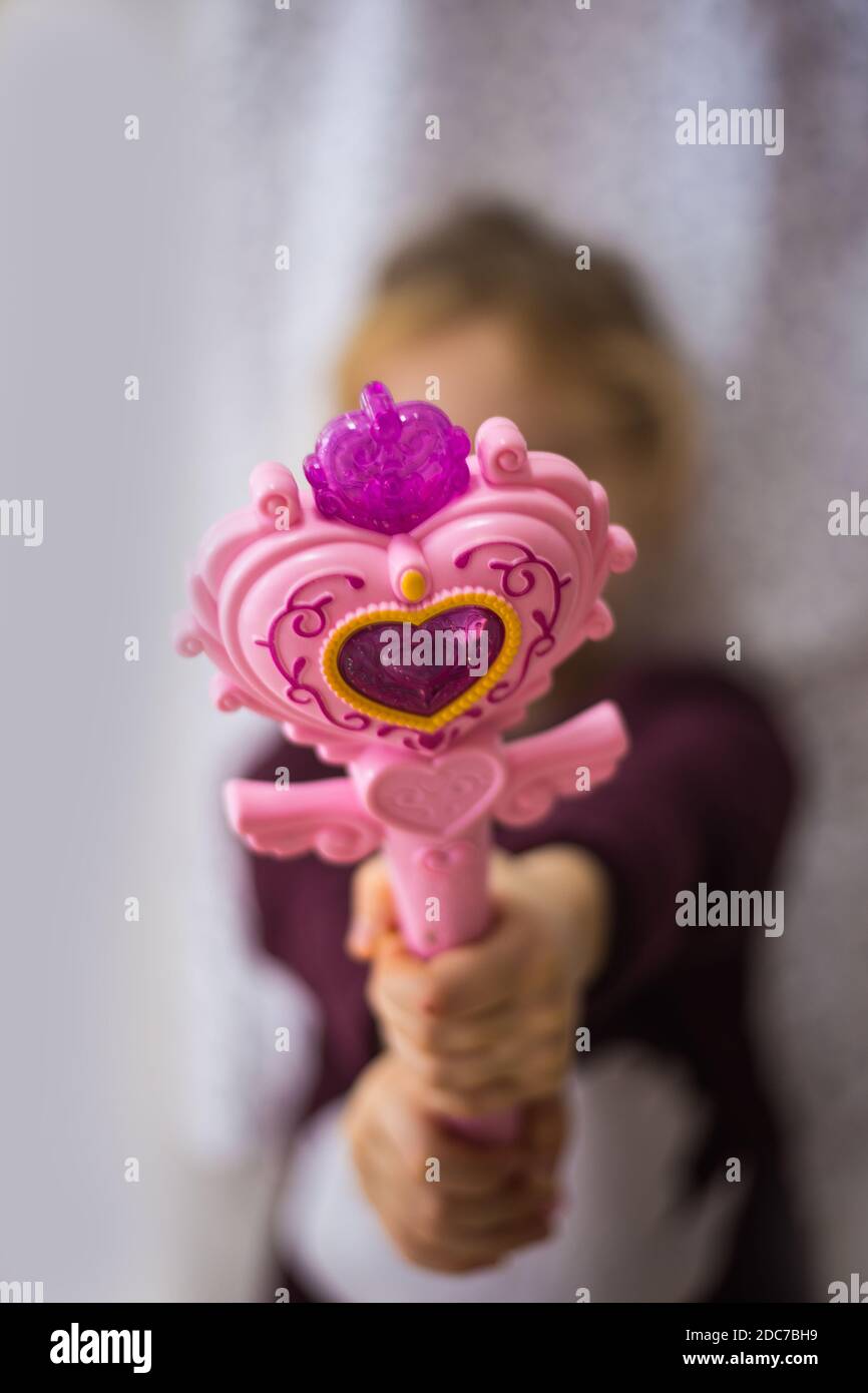 A child hand holding a magic wand Stock Photo - Alamy