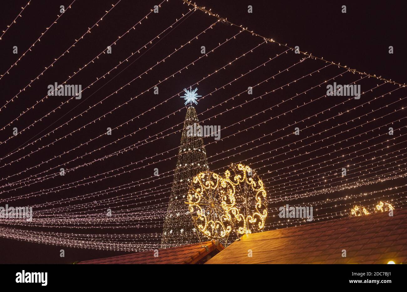 Huge Christmas tree full of lights at a Christmas fair Stock Photo - Alamy